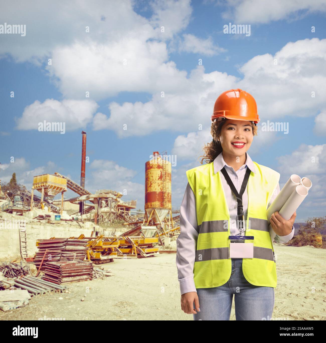 Asian female engineer in a reflective vests holding blueprints at a ...