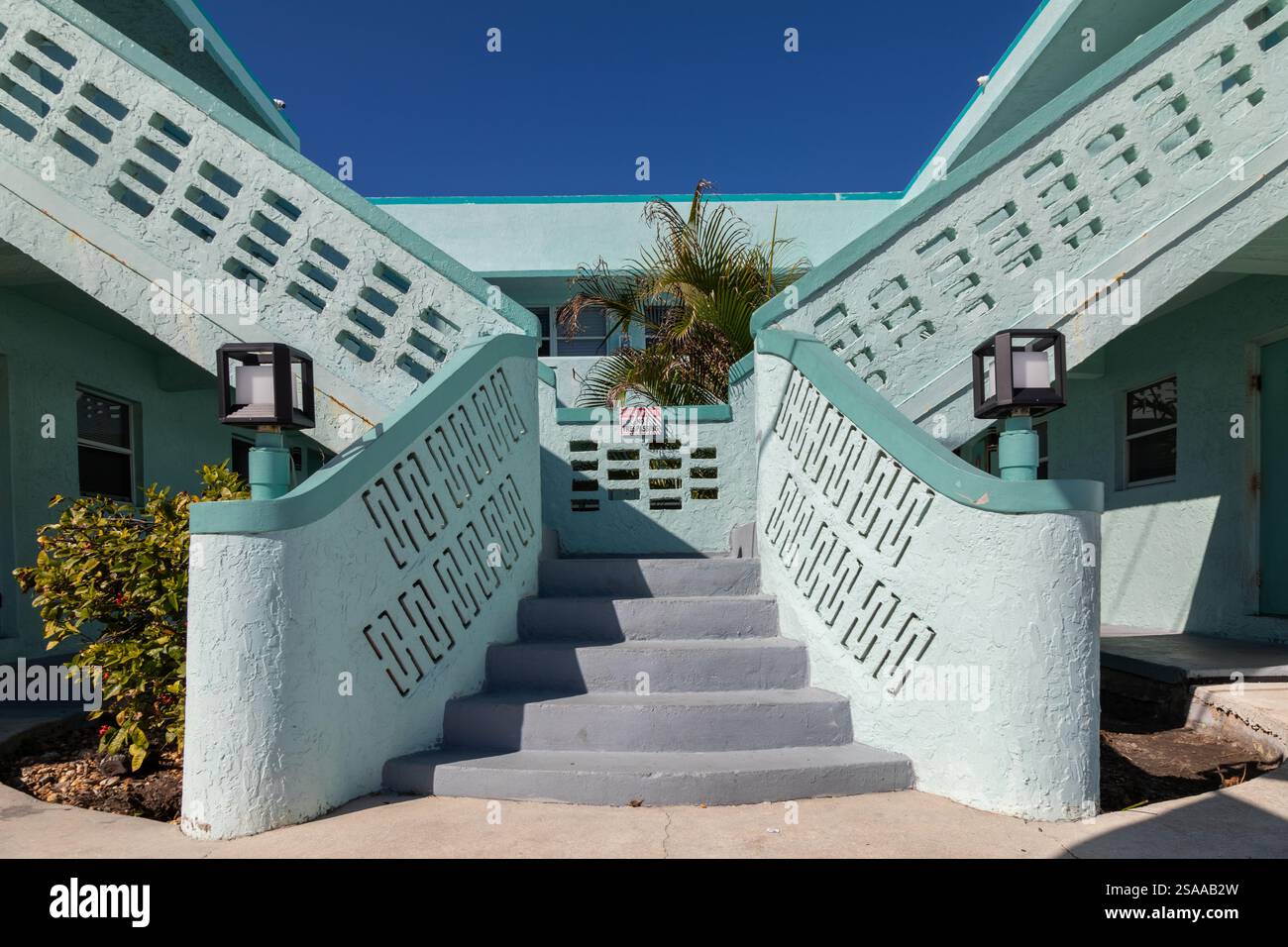 Vintage pastel-colored motel with retro architectural details in ...