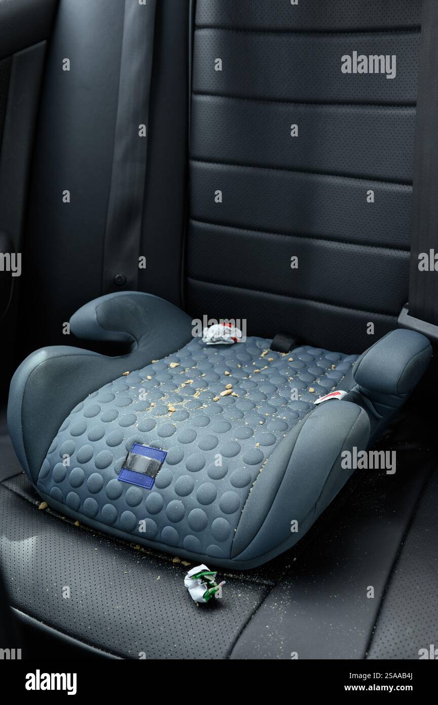 Child car seat, booster, securely fastened to back seat of car in ...