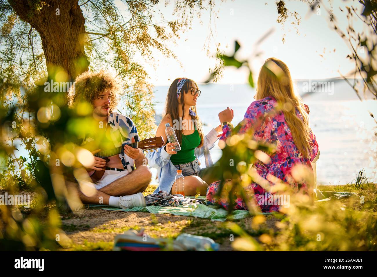 A group of friends gather on the beach sharing joyful moments filled ...