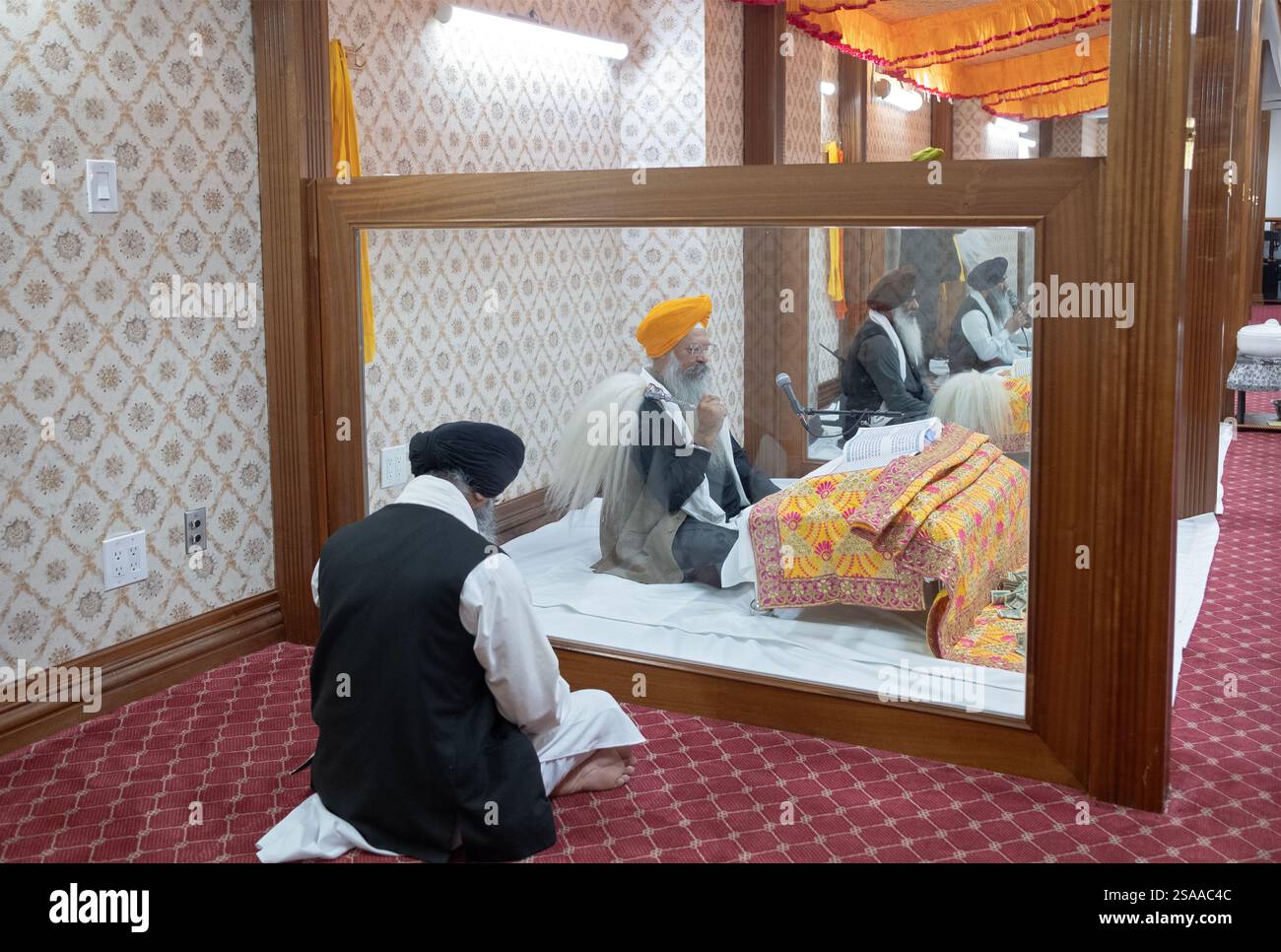 3 Sikh priests read their bibles at an Akhand Path service & a 4th ...