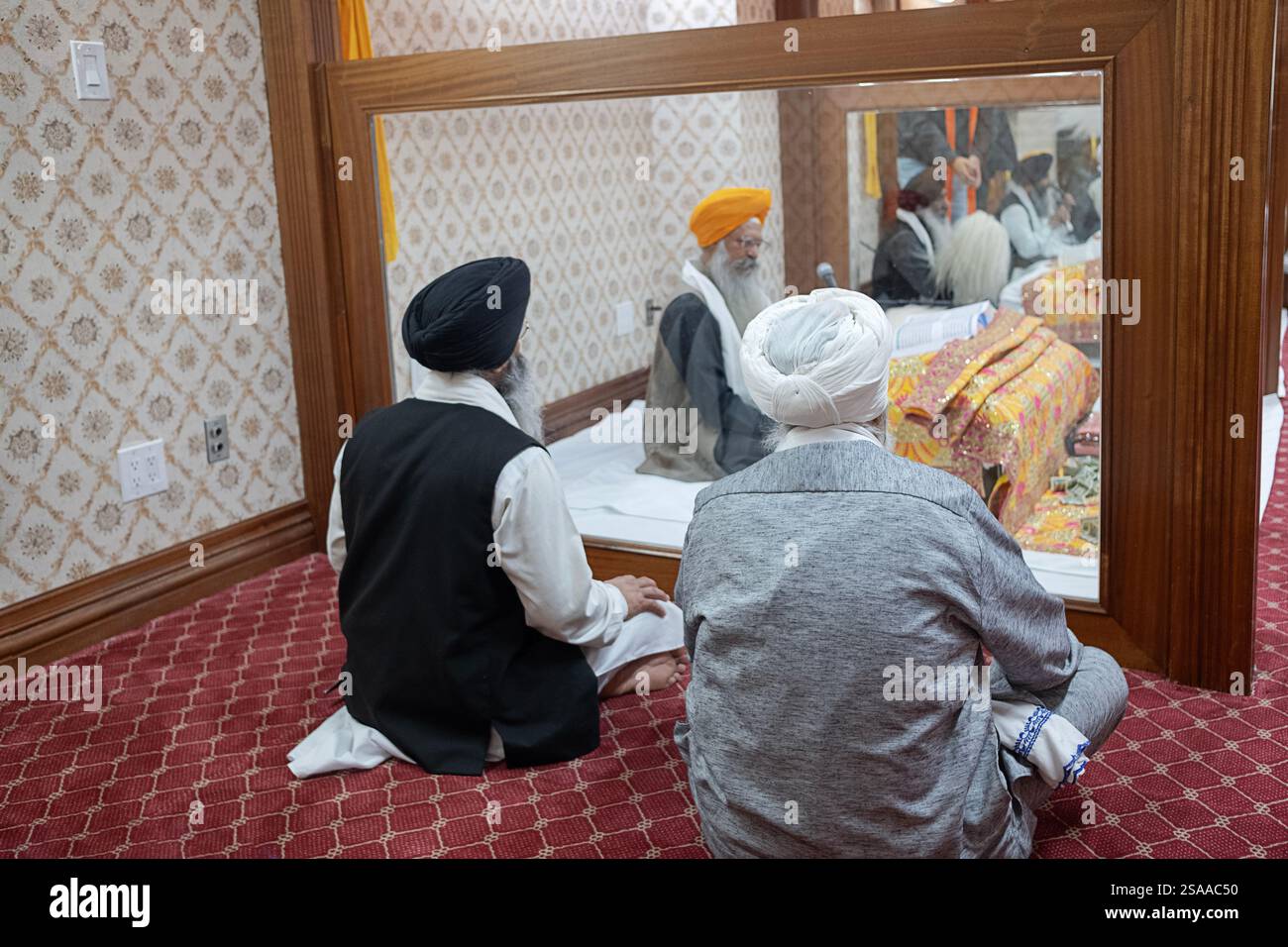 As priests read their bibles at an Akhand Path service & onlookers ...