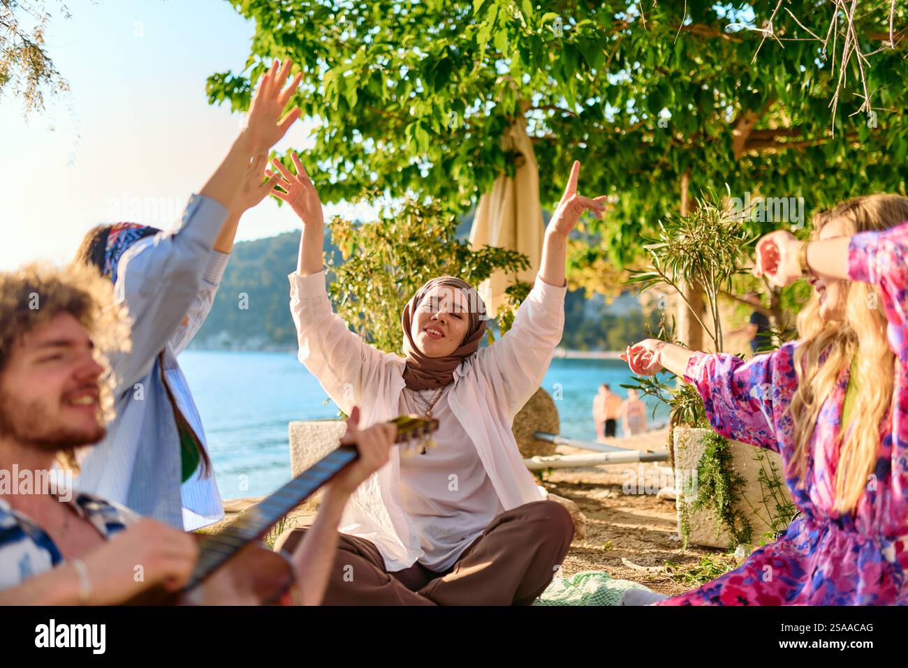 A group of friends gather on the beach sharing joyful moments filled ...