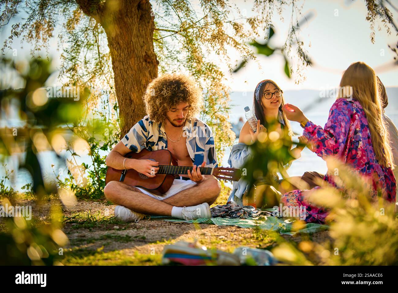 A group of friends gather on the beach sharing joyful moments filled ...