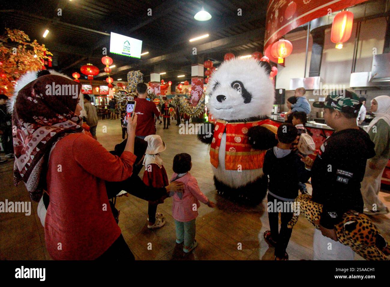 Bogor, Indonesia. 29th Jan, 2025. A worker wearing a festive giant ...