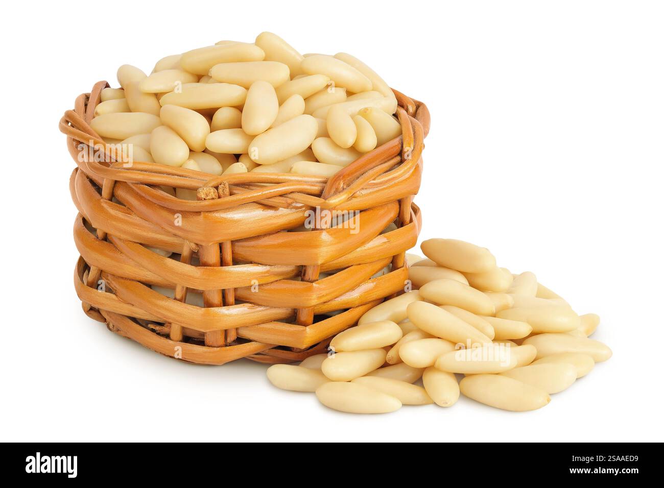 Shelled European pine nuts in a wicker basket isolated on white ...