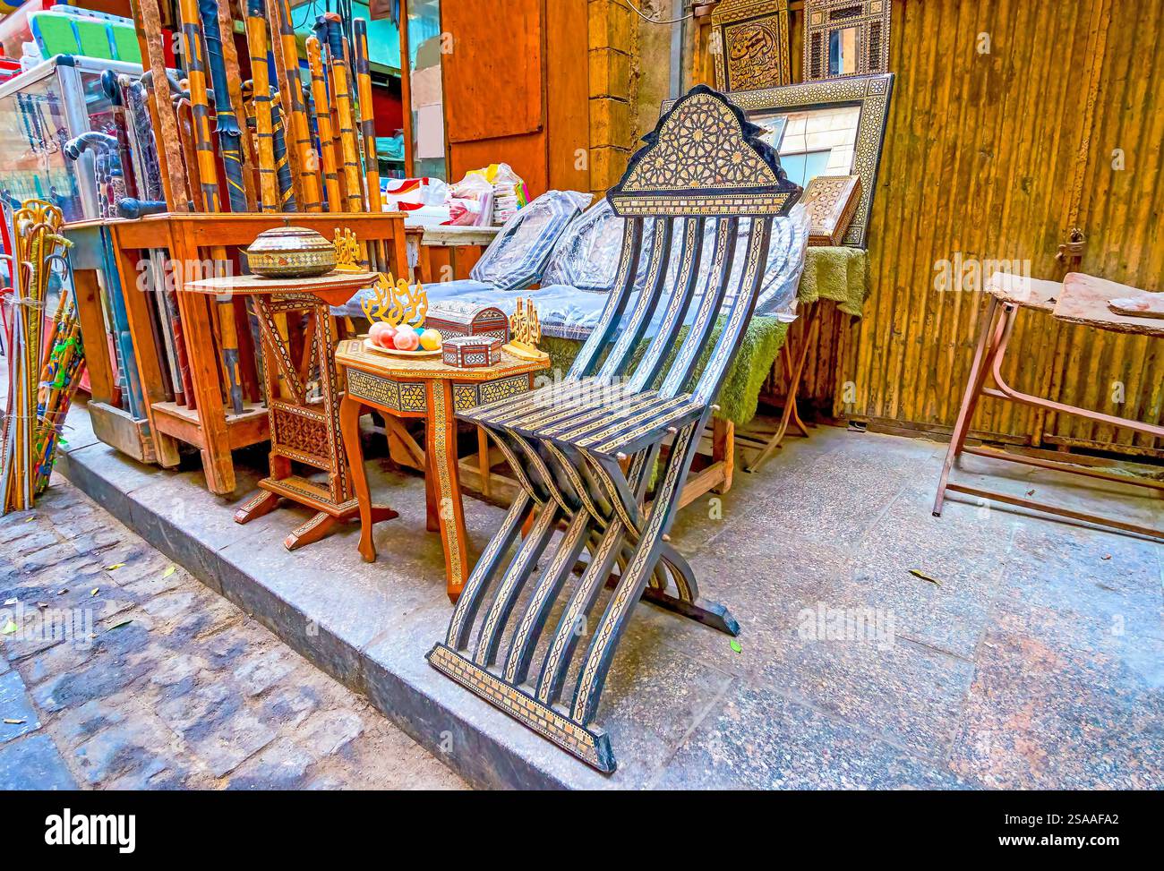 Traditional handmade wooden foldable chair with nacre and ivory inlays in stall of Khan El ...