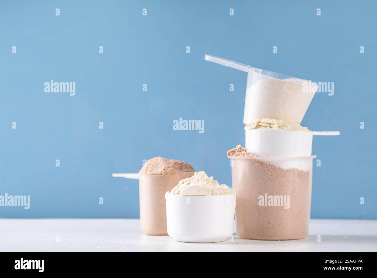 Different protein flavors in plastic scoops. Protein powder shakes for ...