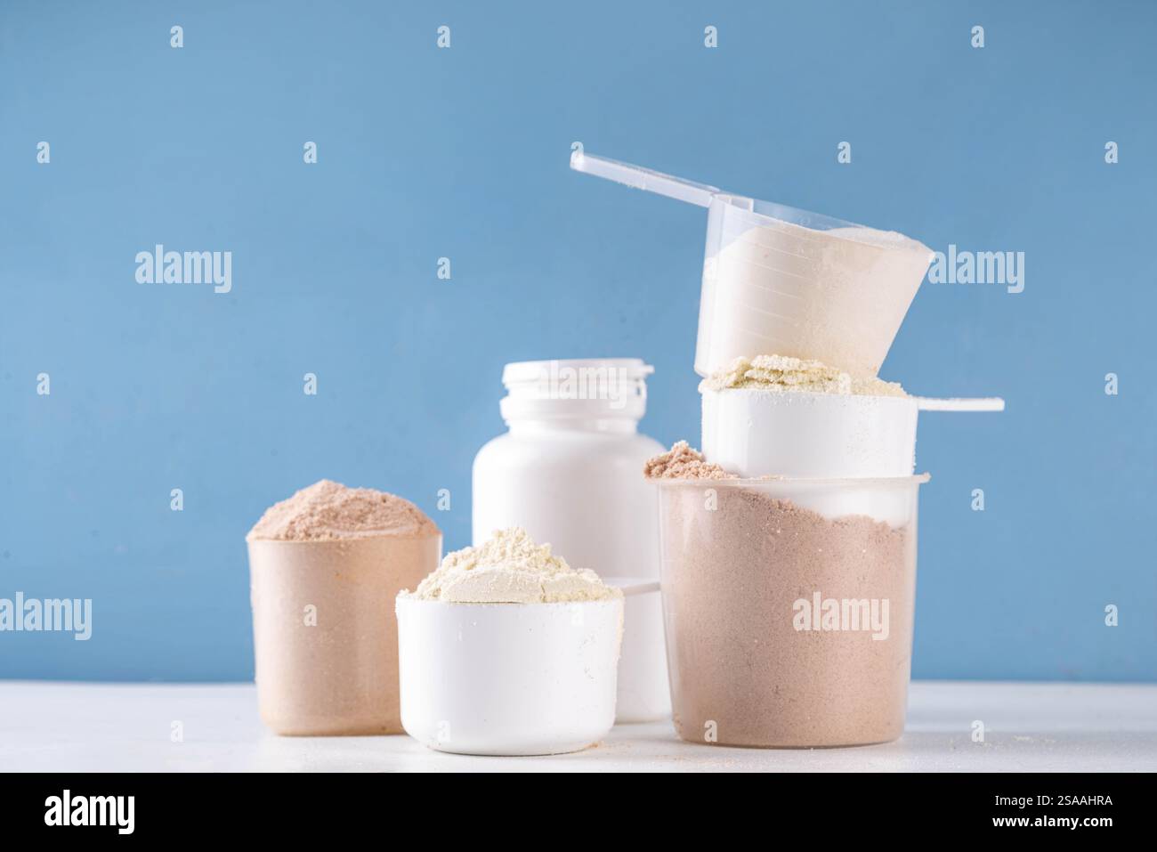 Different protein flavors in plastic scoops. Protein powder shakes for ...