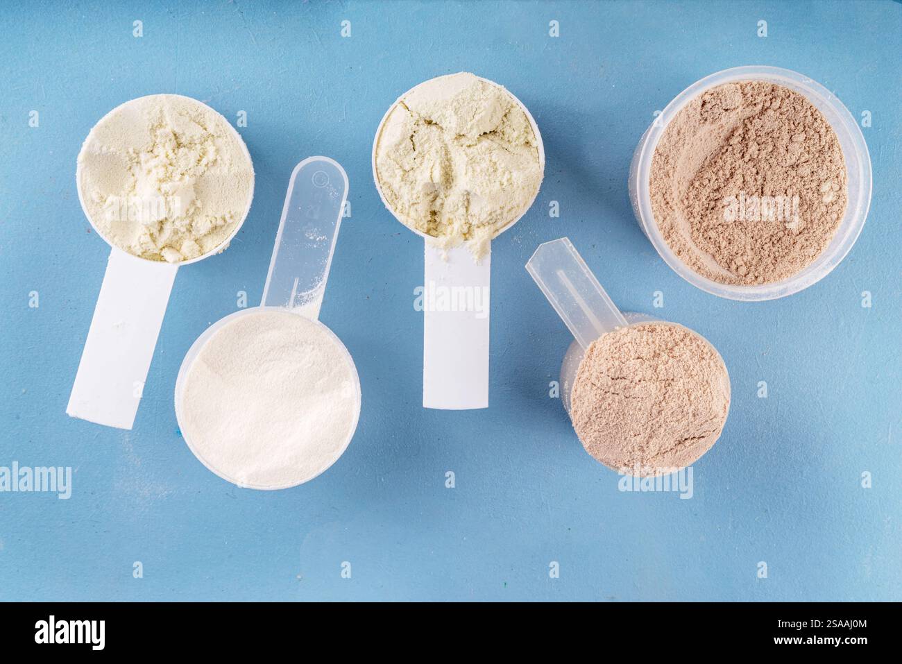 Different protein flavors in plastic scoops. Protein powder shakes for ...