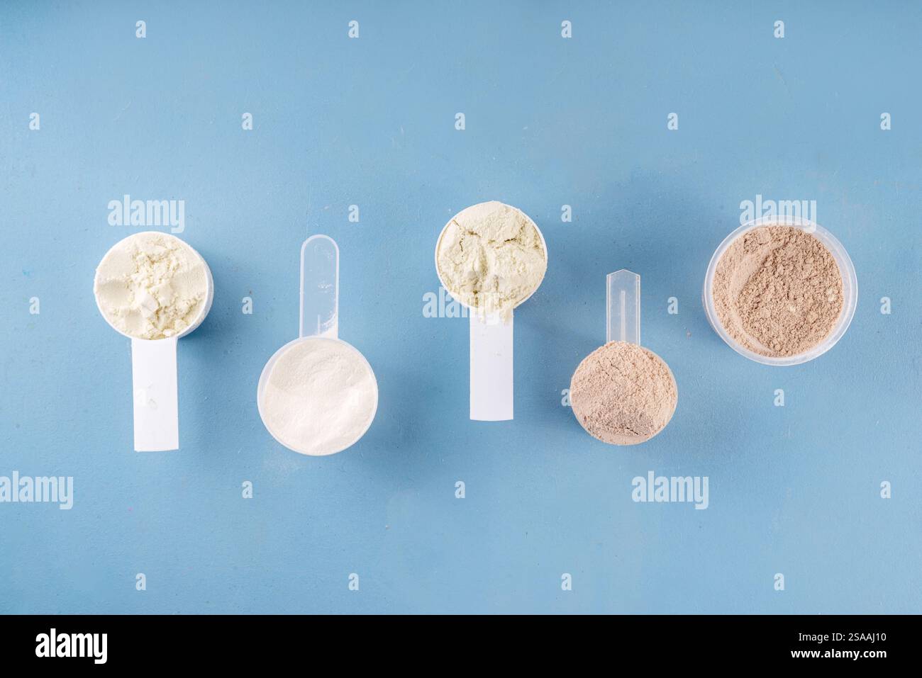 Different protein flavors in plastic scoops. Protein powder shakes for ...