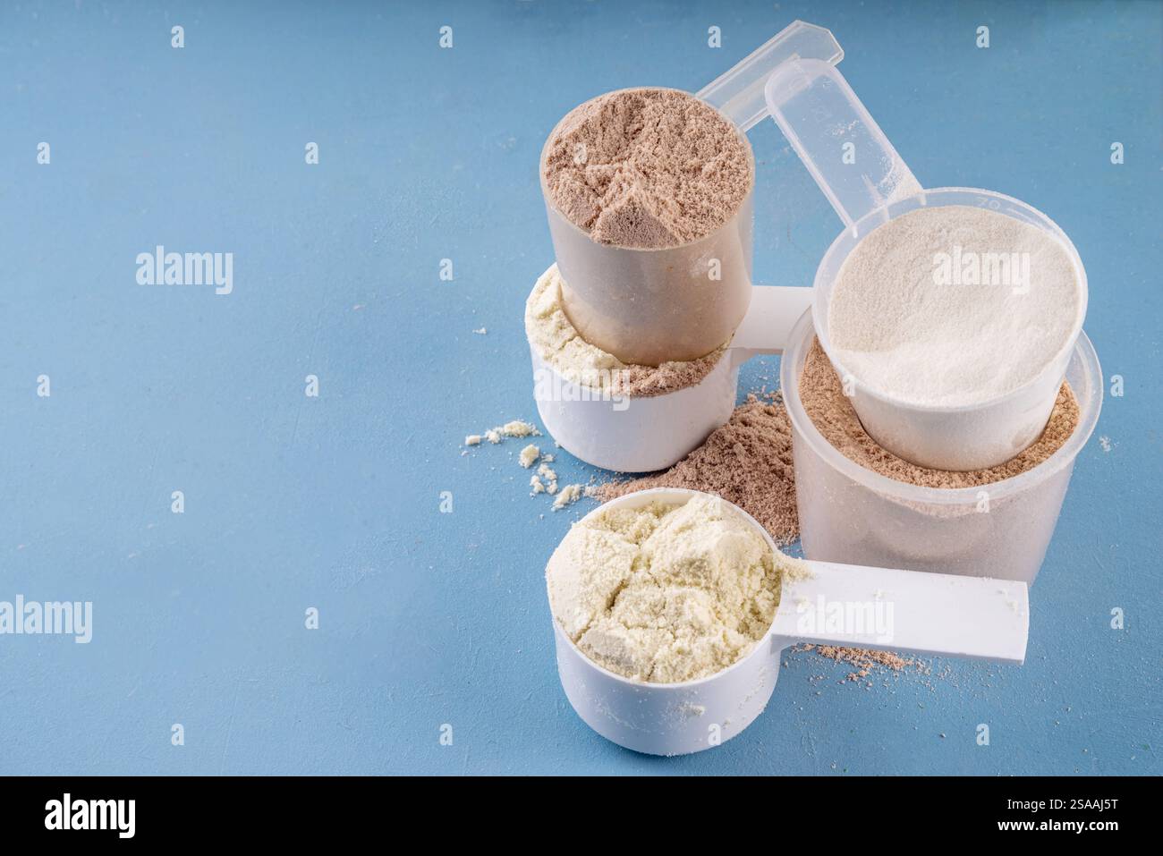 Different protein flavors in plastic scoops. Protein powder shakes for ...