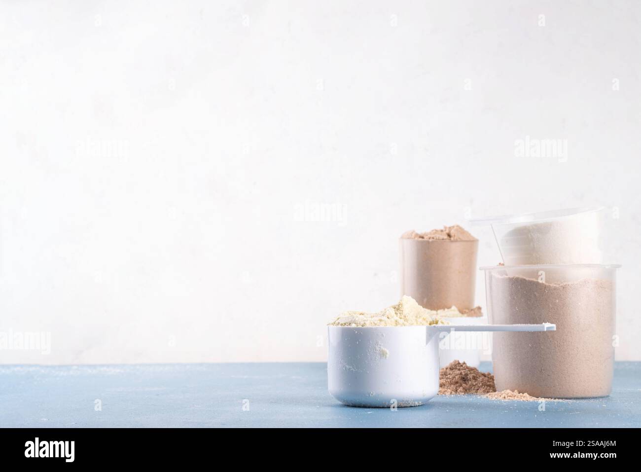 Different protein flavors in plastic scoops. Protein powder shakes for ...