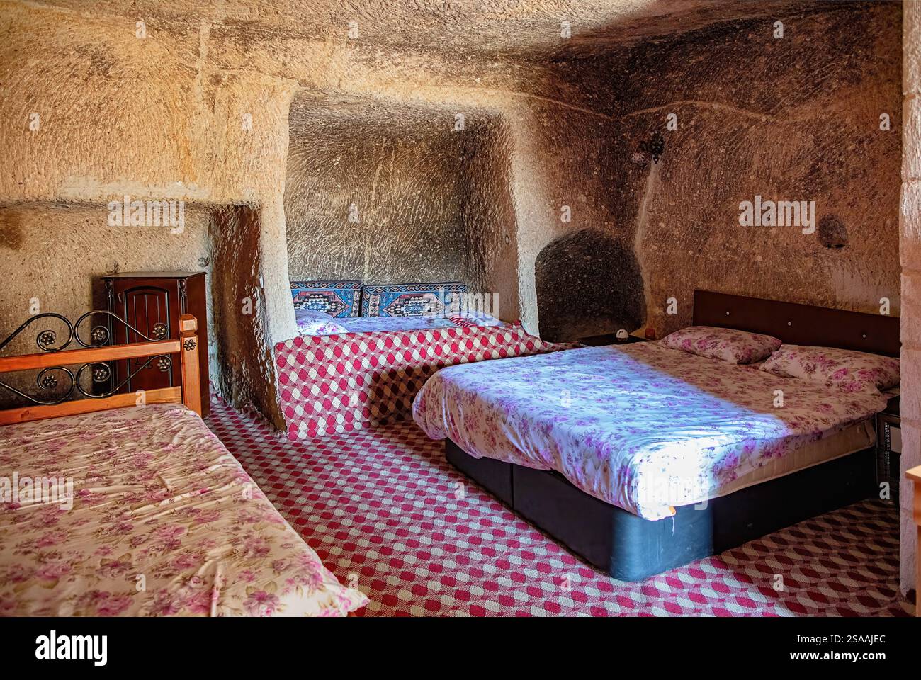 Unique cave accommodation showcasing rustic charm and comfortable beds ...