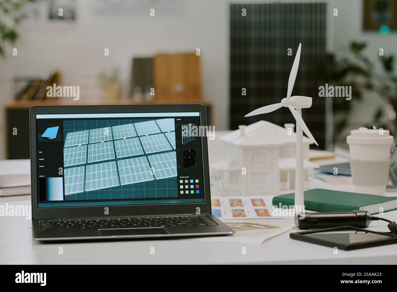 Workspace featuring laptop displaying solar panel design, alongside ...