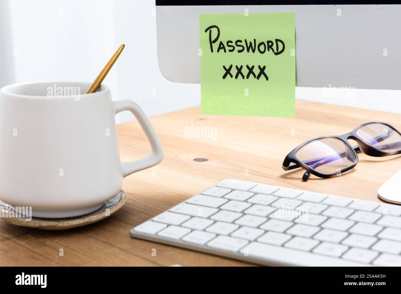 An office setting where a sticky note with a password is attached to a ...