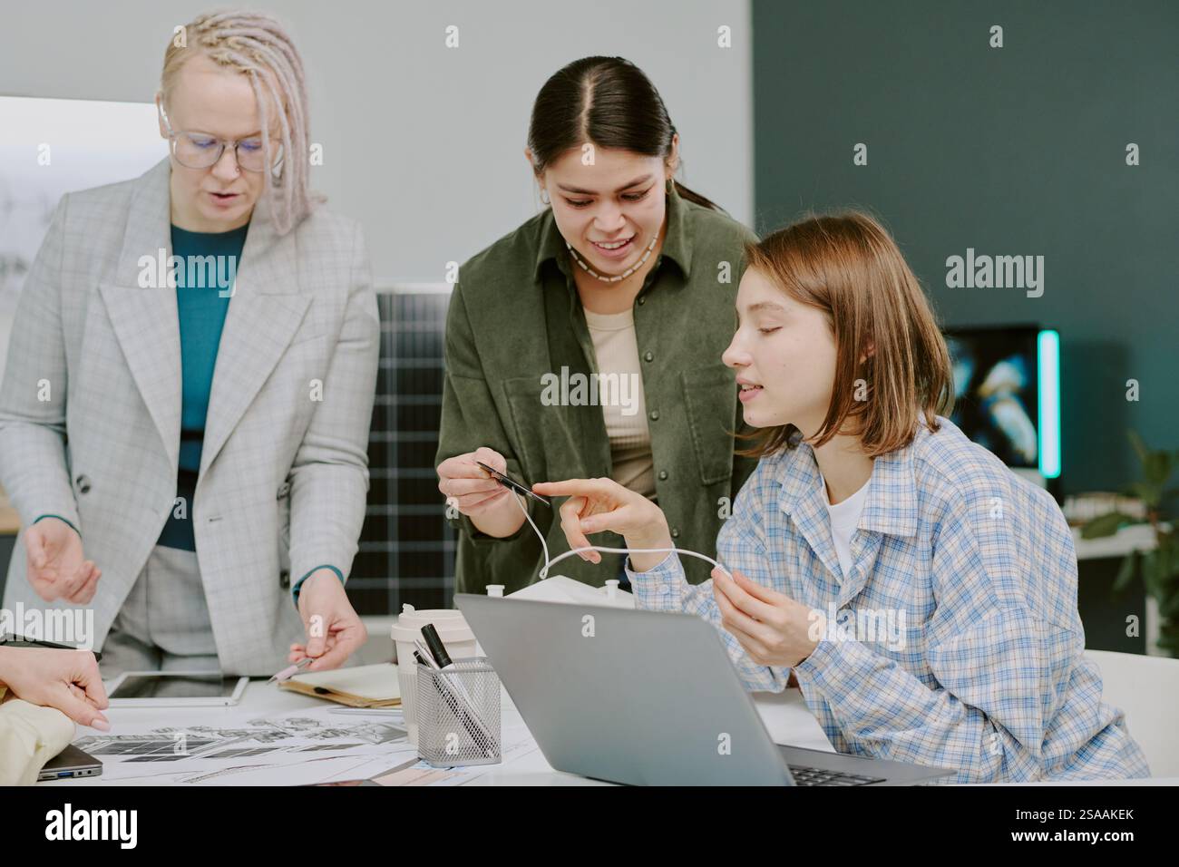 Group of professionals working together, reviewing documents, and ...