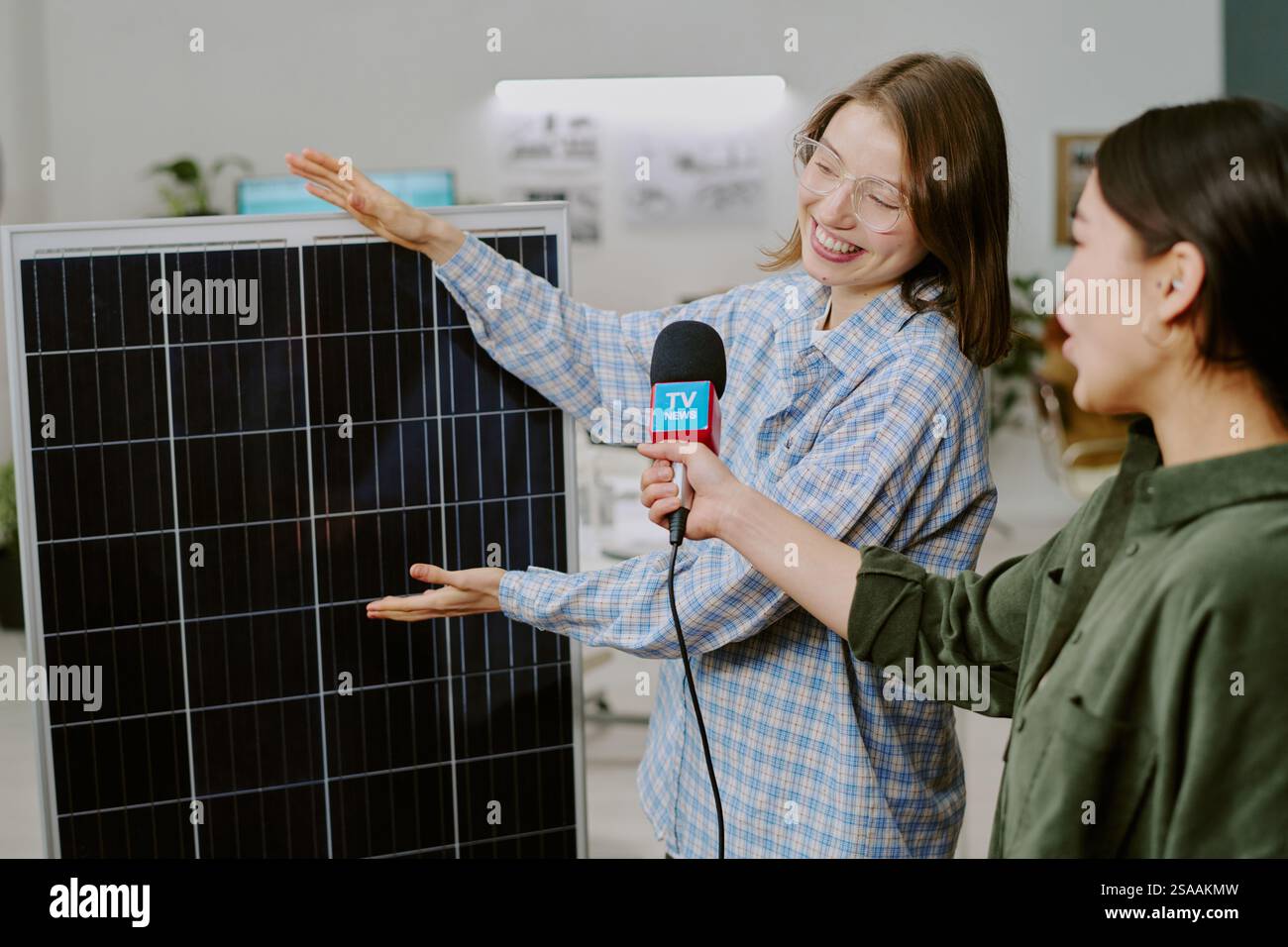 Presenter wearing headphones explaining solar panel features while ...