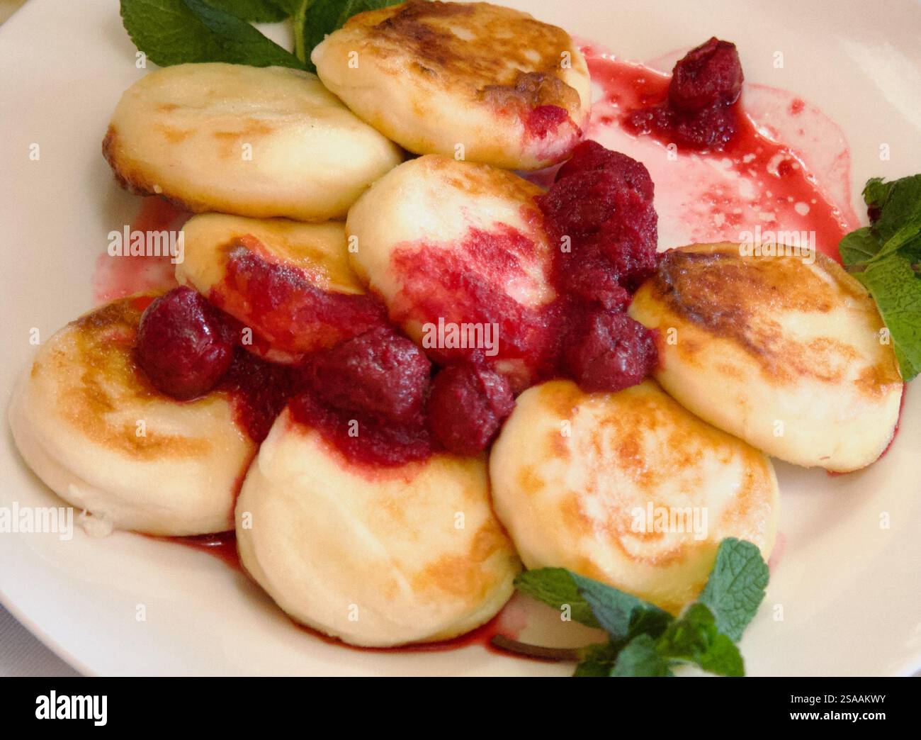 cheesecakes with raspberry jam for breakfast Stock Photo - Alamy