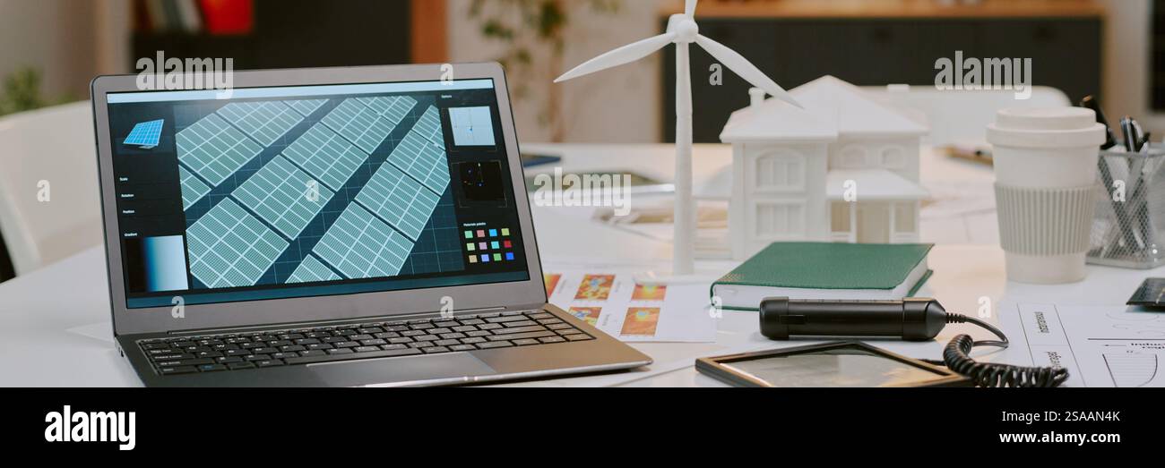 Workstation with laptop displaying solar panel designs and prototype ...