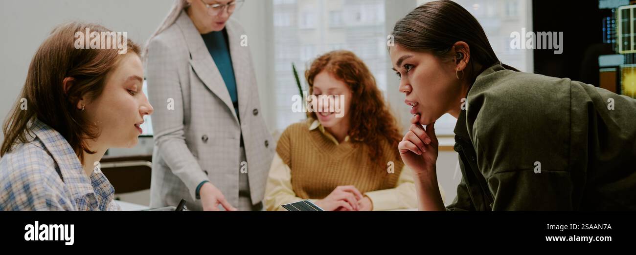 Group of colleagues engaging in discussion during work meeting in ...