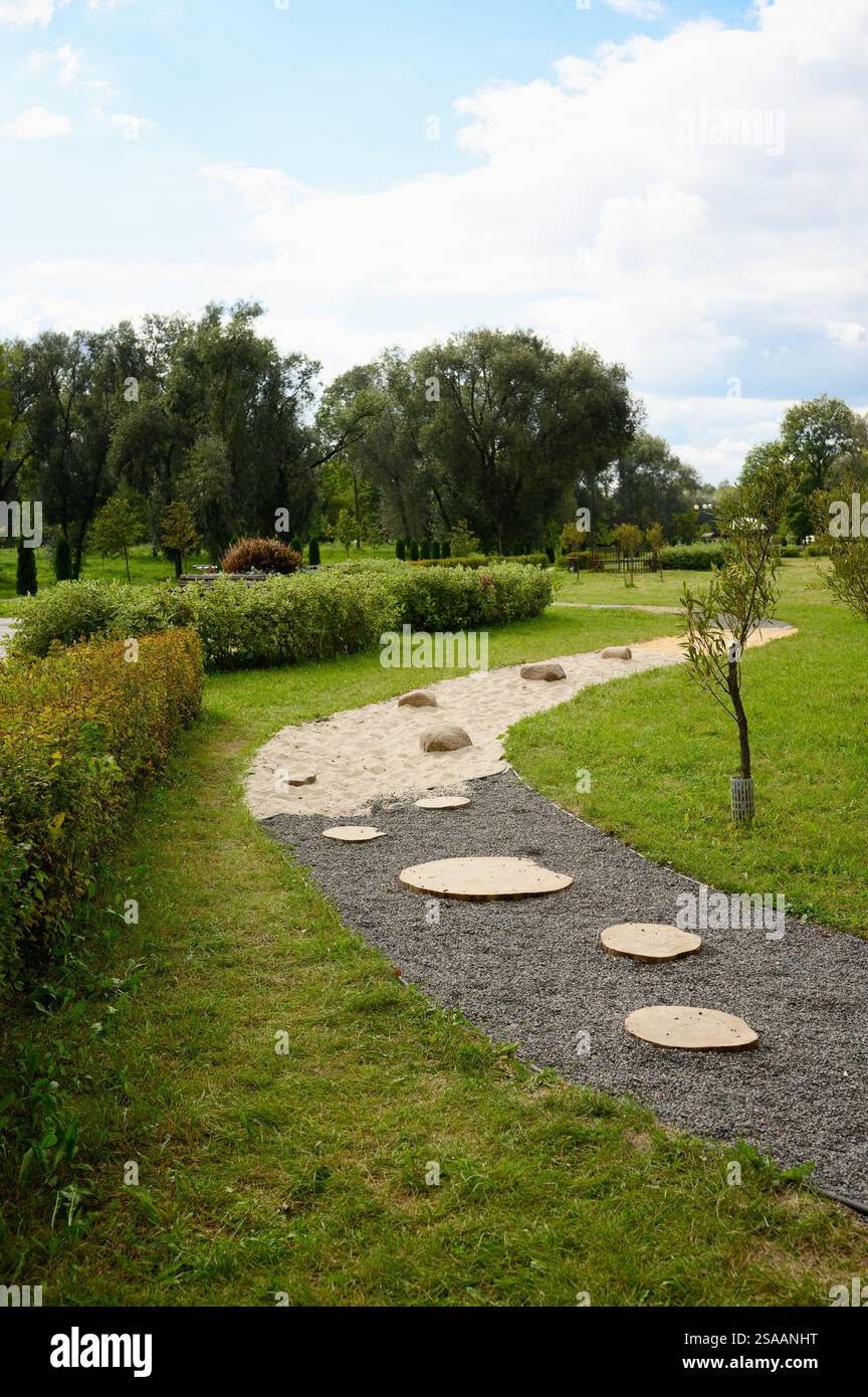 Tactile massage eco-trail with different textures in a city park among ...