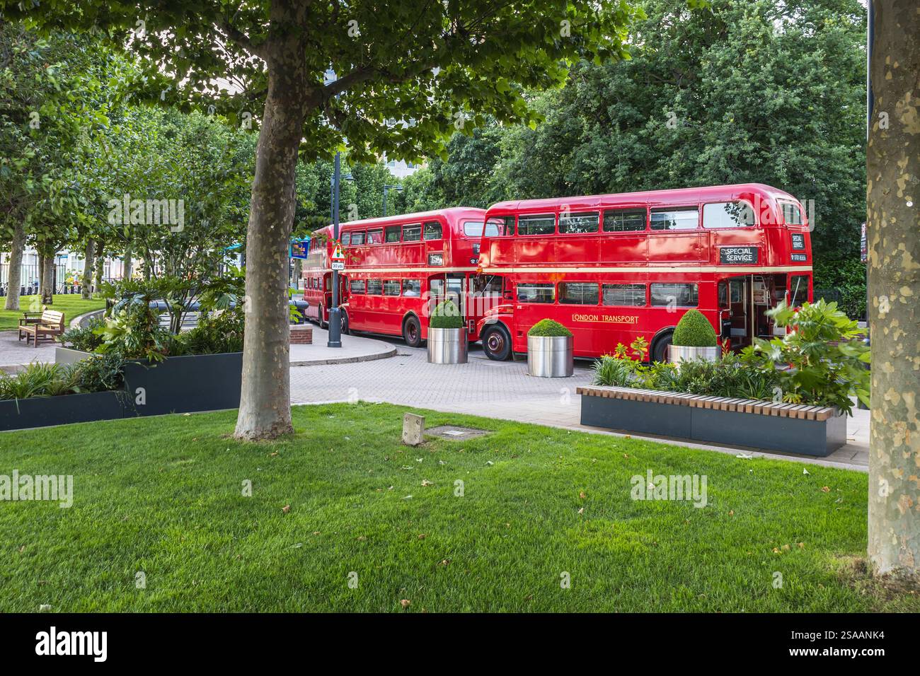 Iconic London Red Buses in a Scenic Park Setting Stock Photo - Alamy