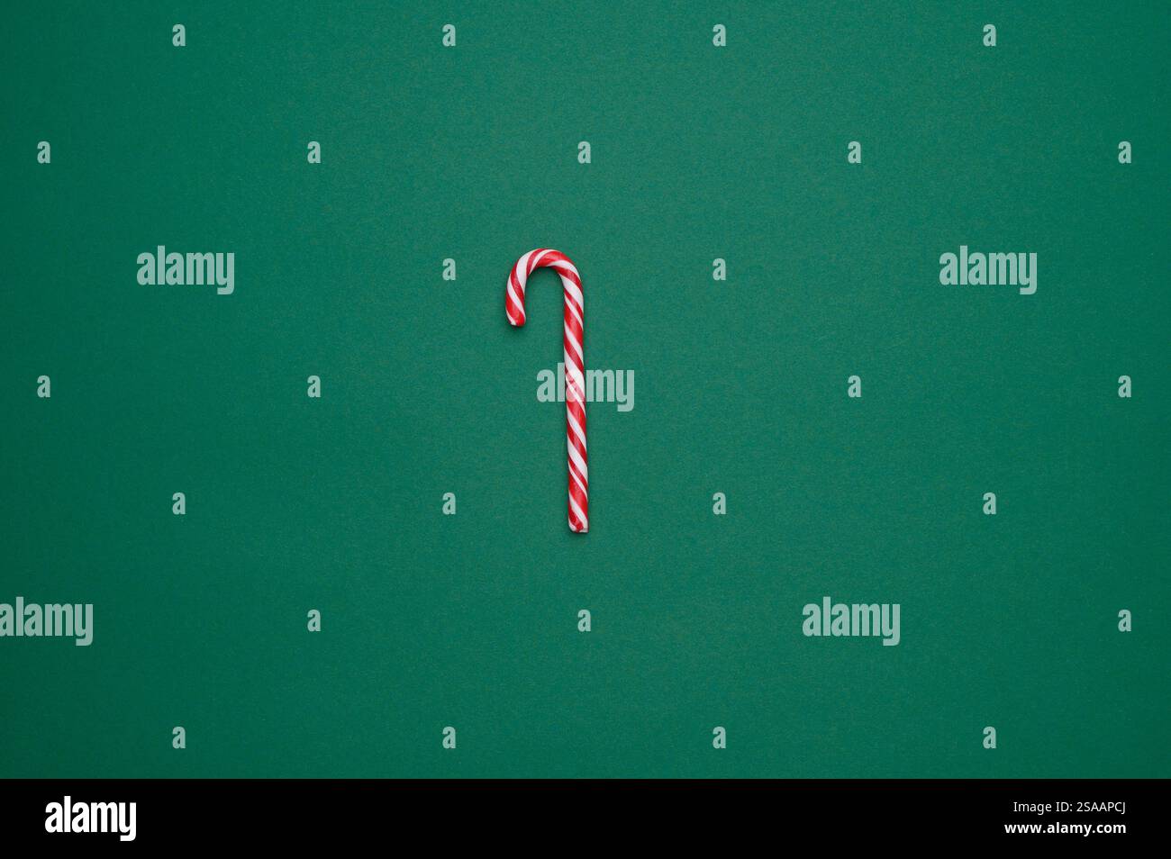 White cane layout with red stripes, sweet christmas candy on green ...