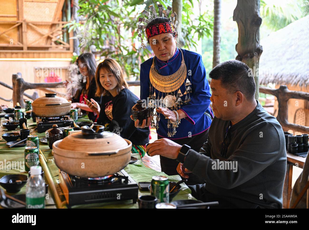 Baoting, China's Hainan Province. 28th Jan, 2025. A villager serves ...