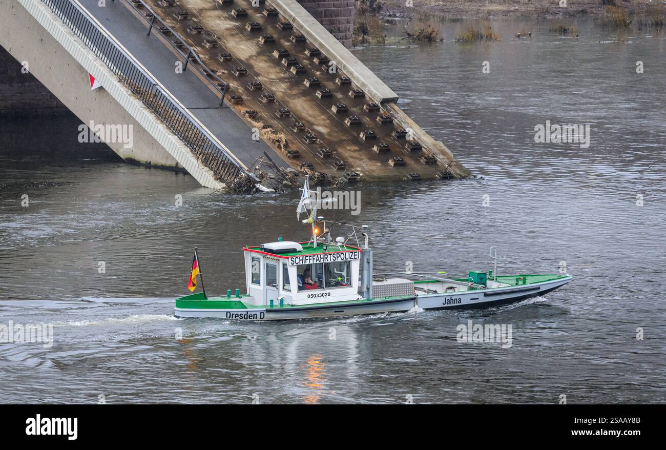 Dresden, Germany. 28th Jan, 2025. A maritime police boat passes under ...