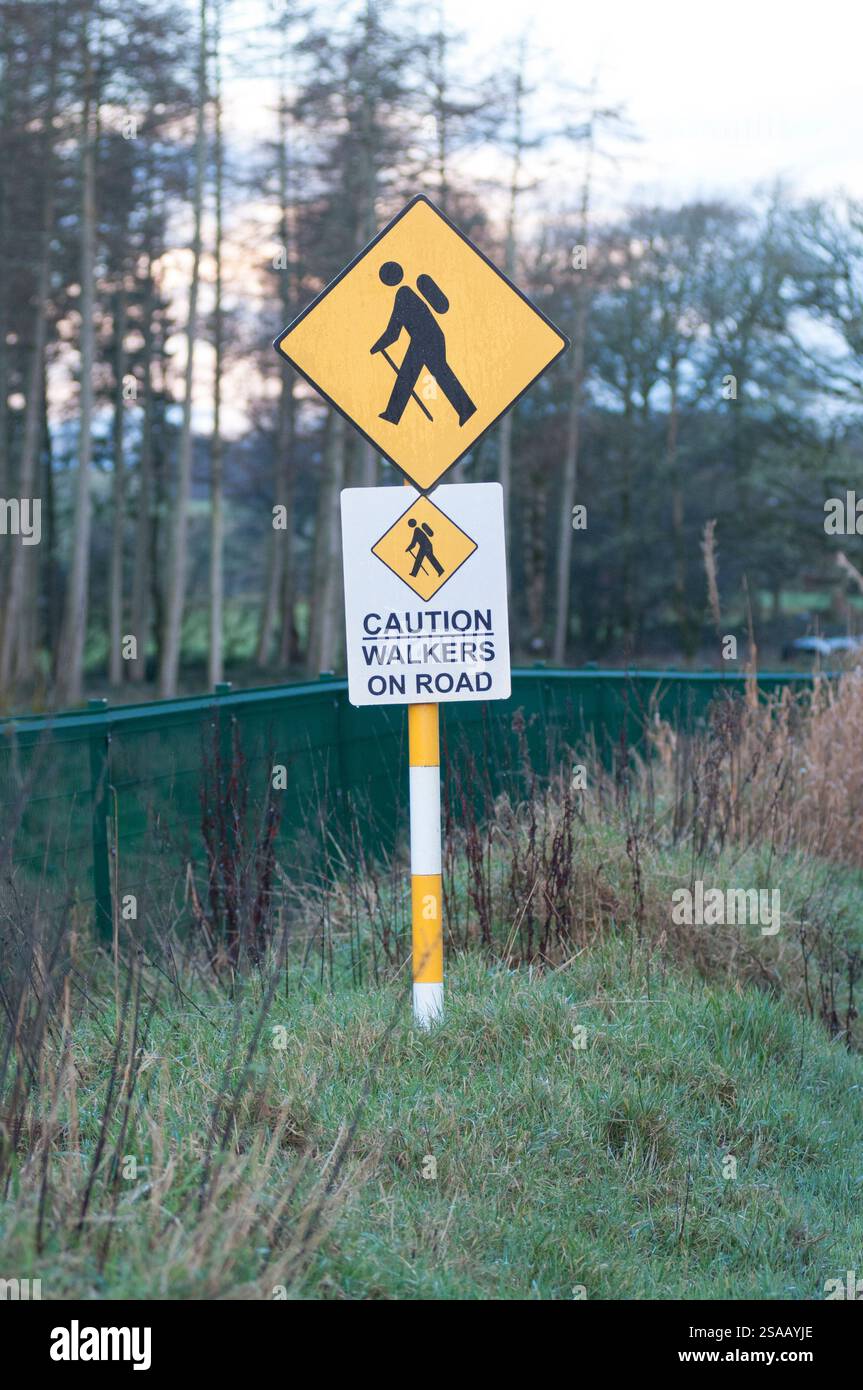 A road safety sign , alerting motorists of walkers on the road Stock ...