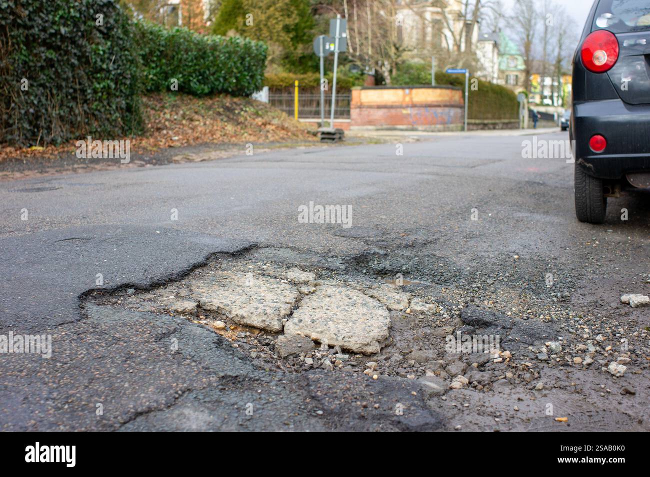 Pothole after frost in winter on a road Stock Photo - Alamy