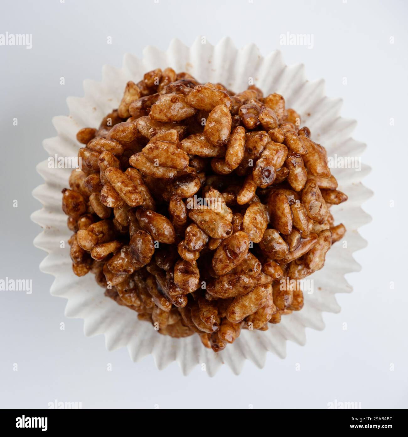 Single chocolate coated rice crispy in paper case viewed from above ...