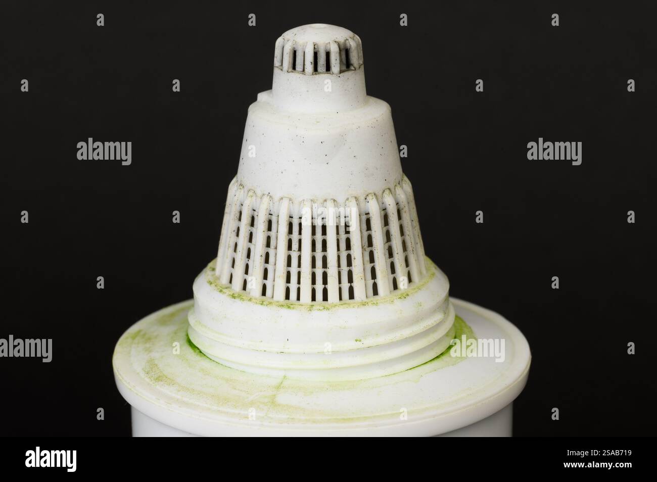 Dirty greenish replaceable filter cartridge for drinking water ...