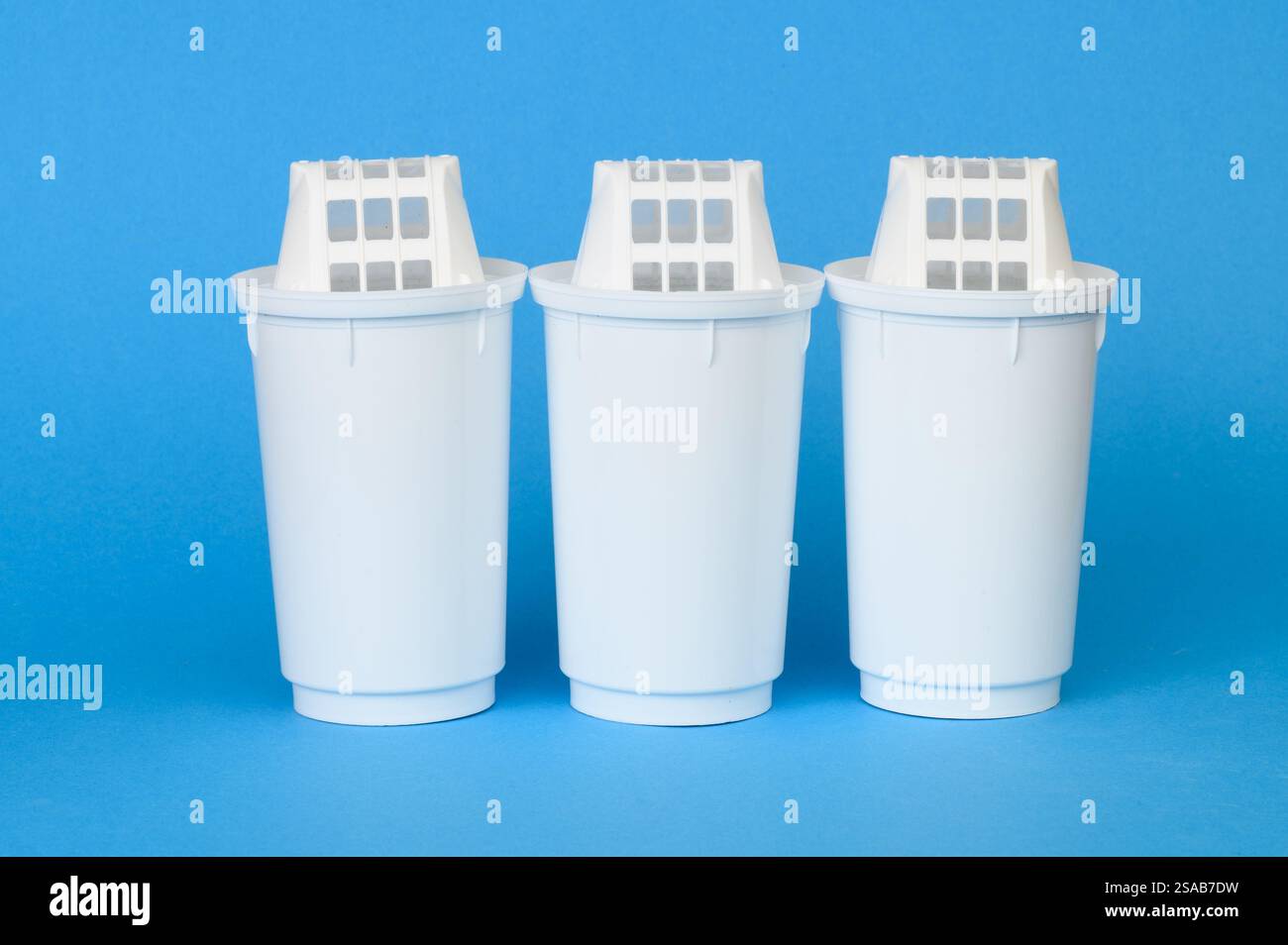 Three new filter cartridges for water purification stand in a row on ...