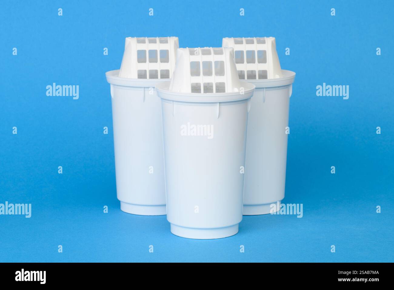 Three water purification cartridges neatly arranged next to each other ...