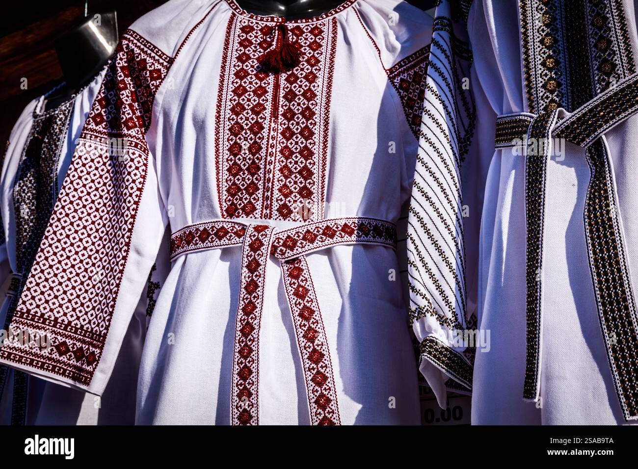 A row of colorful clothing with red and white patterns. The clothing is ...