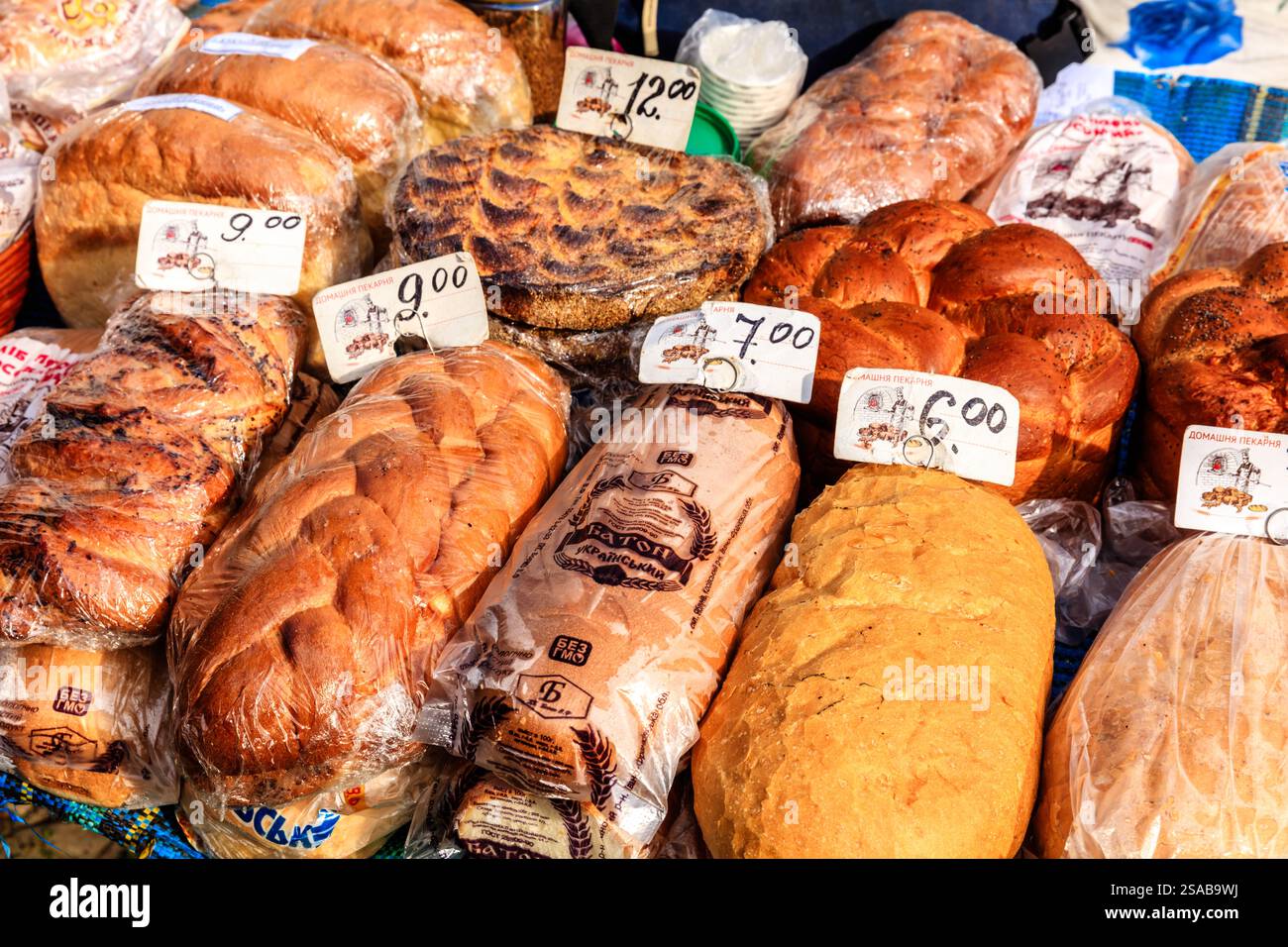 A table full of breads with prices on them. The breads are all ...