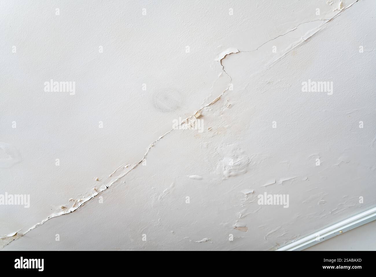 Roof and a crack with rain water seeping into the wall causing damage ...