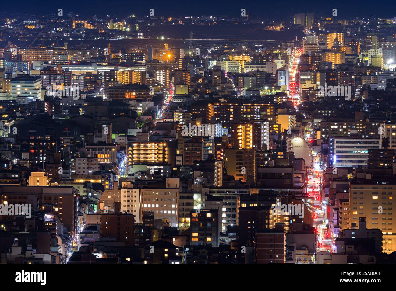 Lights from office and apartment buildings by busy streets at night ...