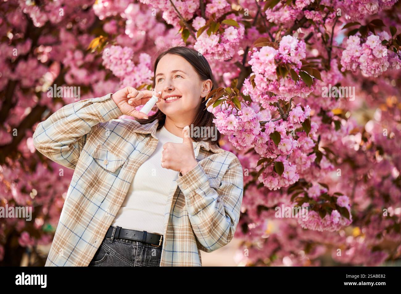 Woman allergic using medical nasal drops, suffering from seasonal ...