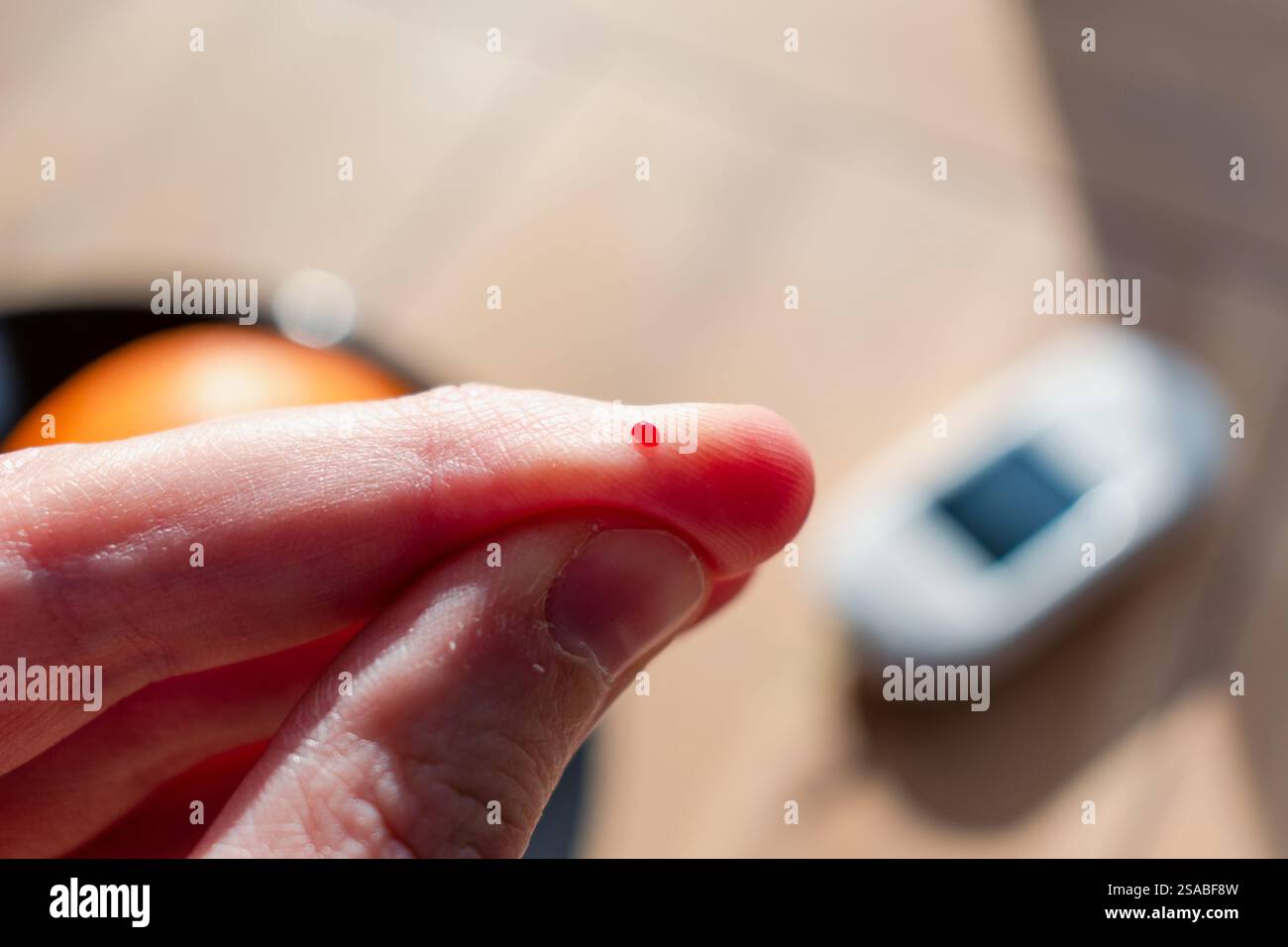 Woman pricking her finger to check blood glucose level with glucometer ...