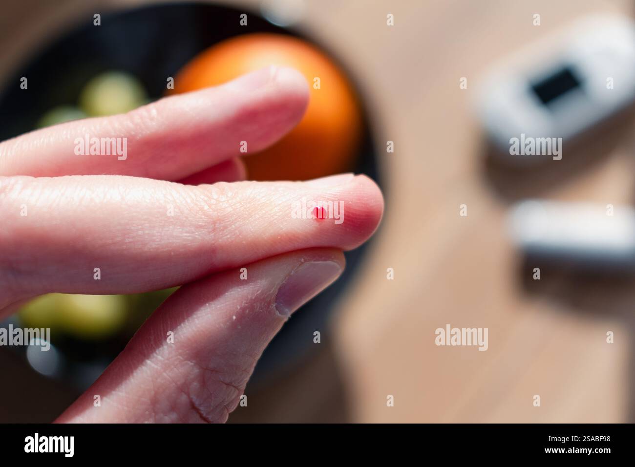 Woman pricking her finger to check blood glucose level with glucometer ...
