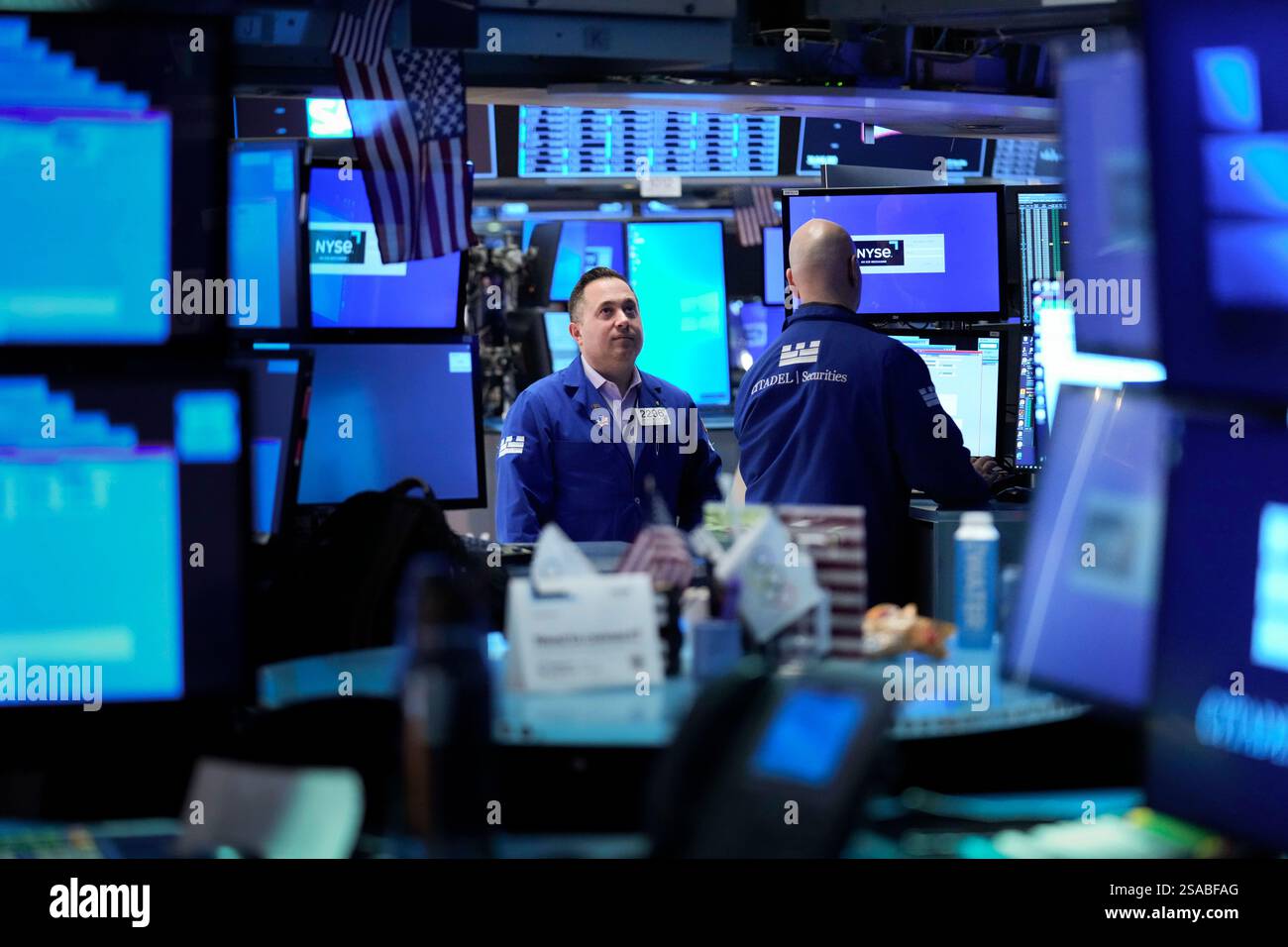 Traders work on the floor at the New York Stock Exchange in New York ...