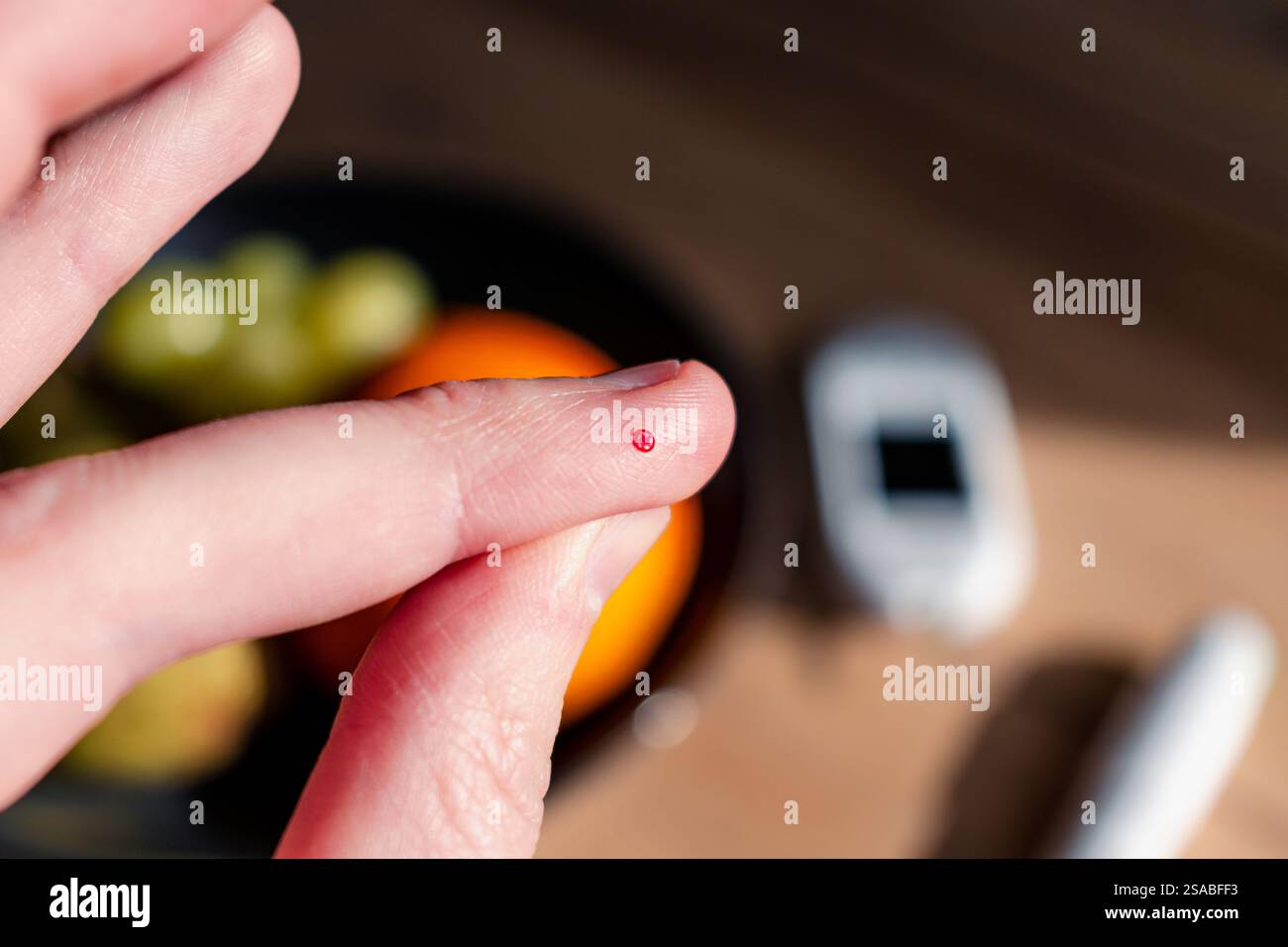 Woman pricking her finger to check blood glucose level with glucometer ...