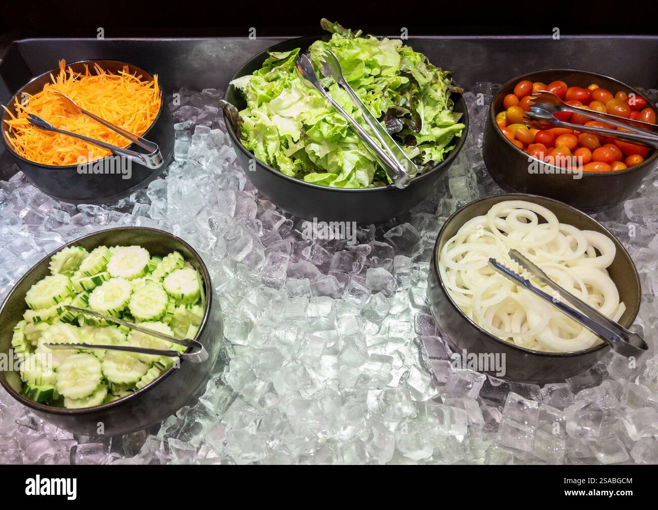 A vibrant salad bar display featuring a variety of fresh vegetables ...