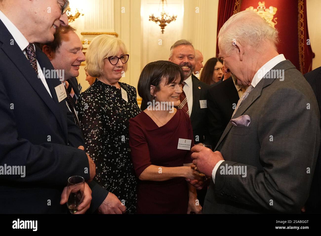 King Charles III talking to Johanna Baxter during a reception for ...
