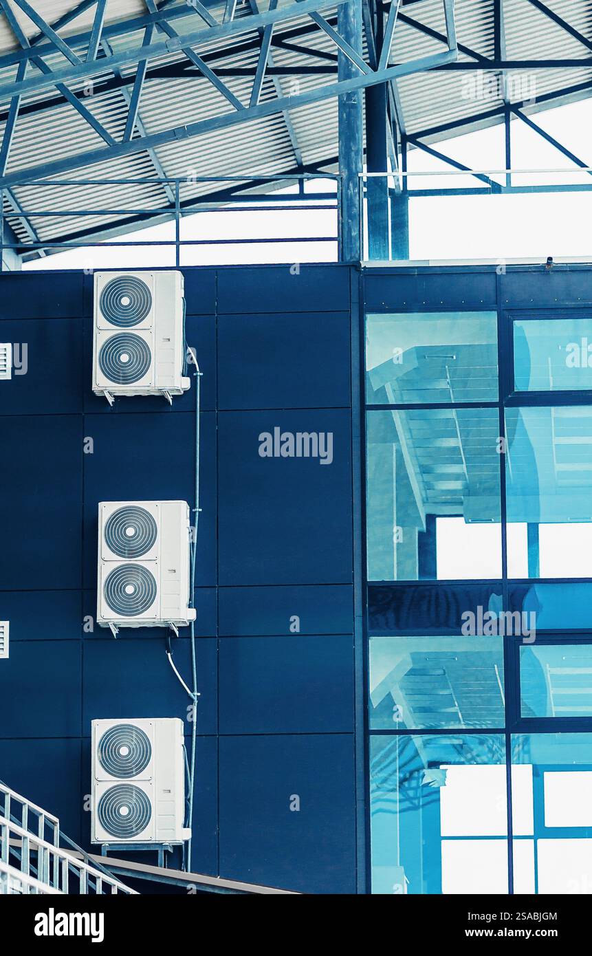 Three concentrators on the wall of a modern building with a ventilated ...