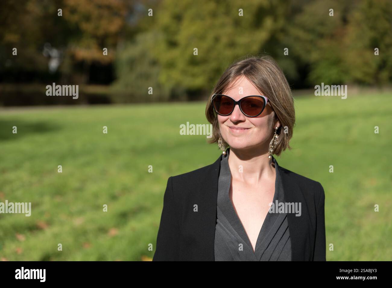 Outdoor portrait of a 31 yo woman in the Stuyvenberg Royal city park ...