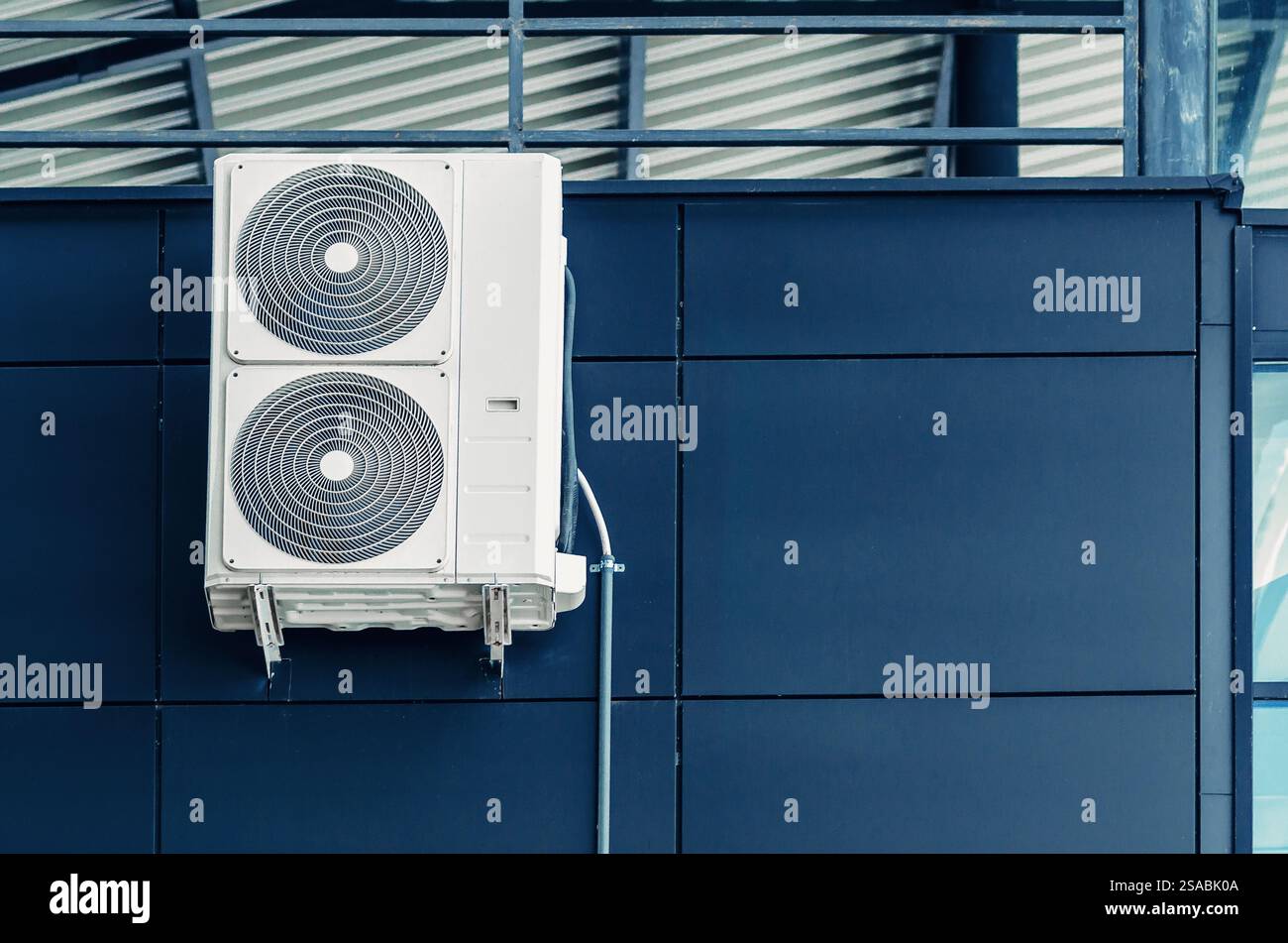 White air conditioner on the wall of a modern building. Ventilation of ...